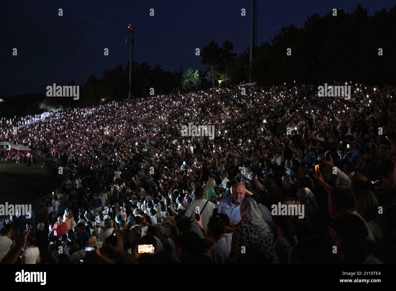Students and families turn on their phone lights at the Revolution ...