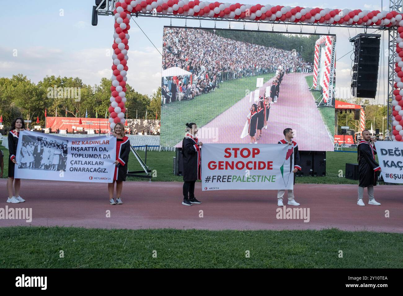 Two students hold a "Stop Genocide" banner during the Revolutionary ...
