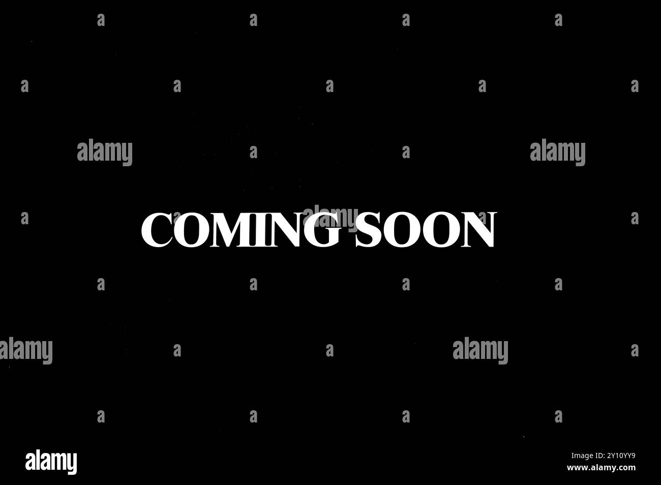 Coming Soon sign in white letters on a black background Stock Photo - Alamy