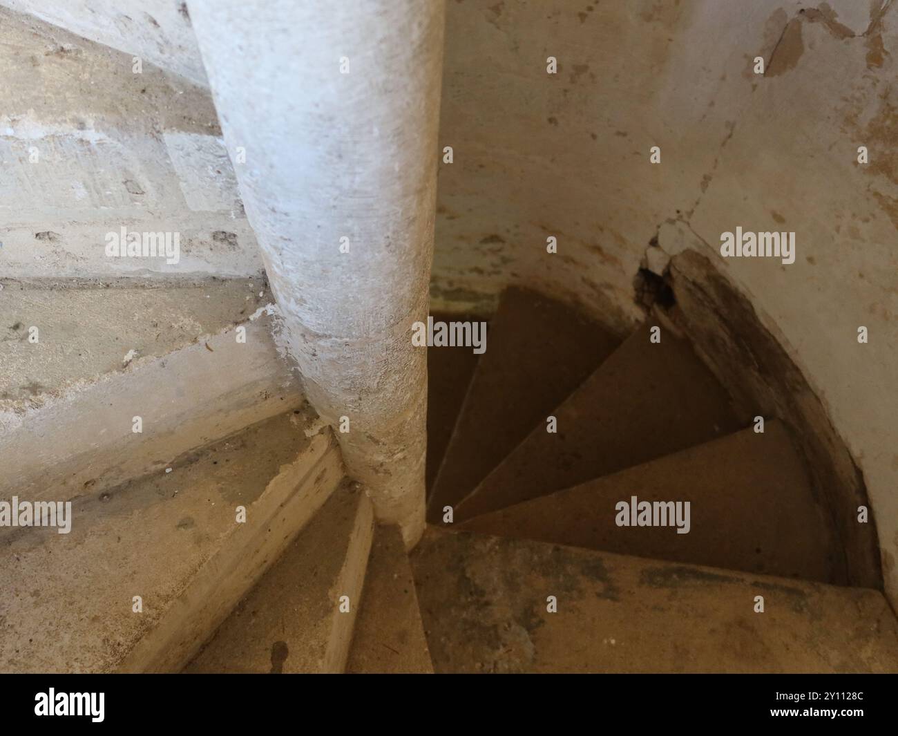 The narrow and steep stone steps of the spiral staircase that connects ...