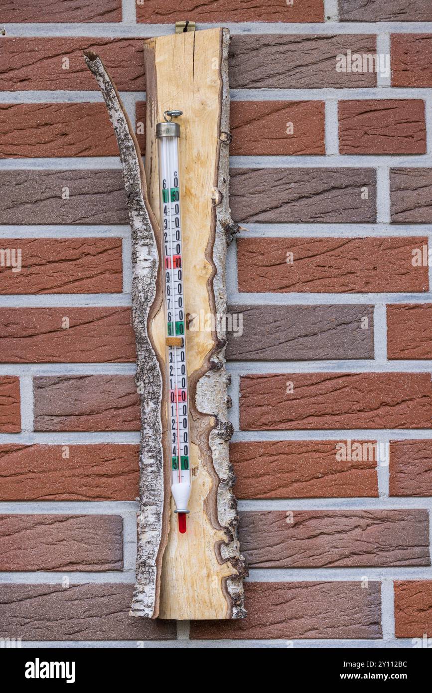 Old thermometer in wooden holder on a house wall, measure temperature ...