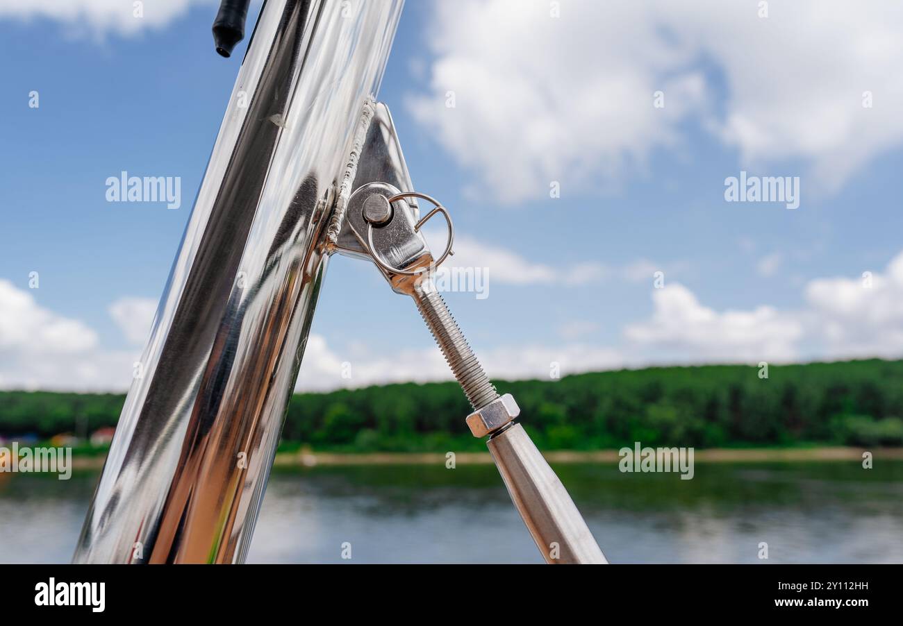Fastening, securing a shade on the sun deck made of chrome, support ...