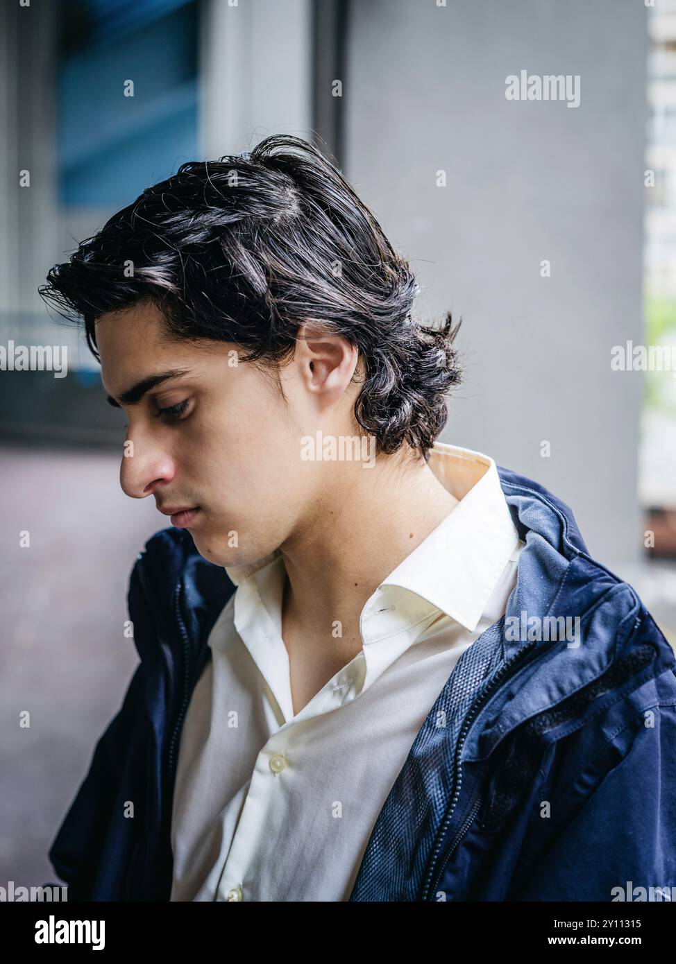 Young man dark hair stands hi-res stock photography and images - Alamy
