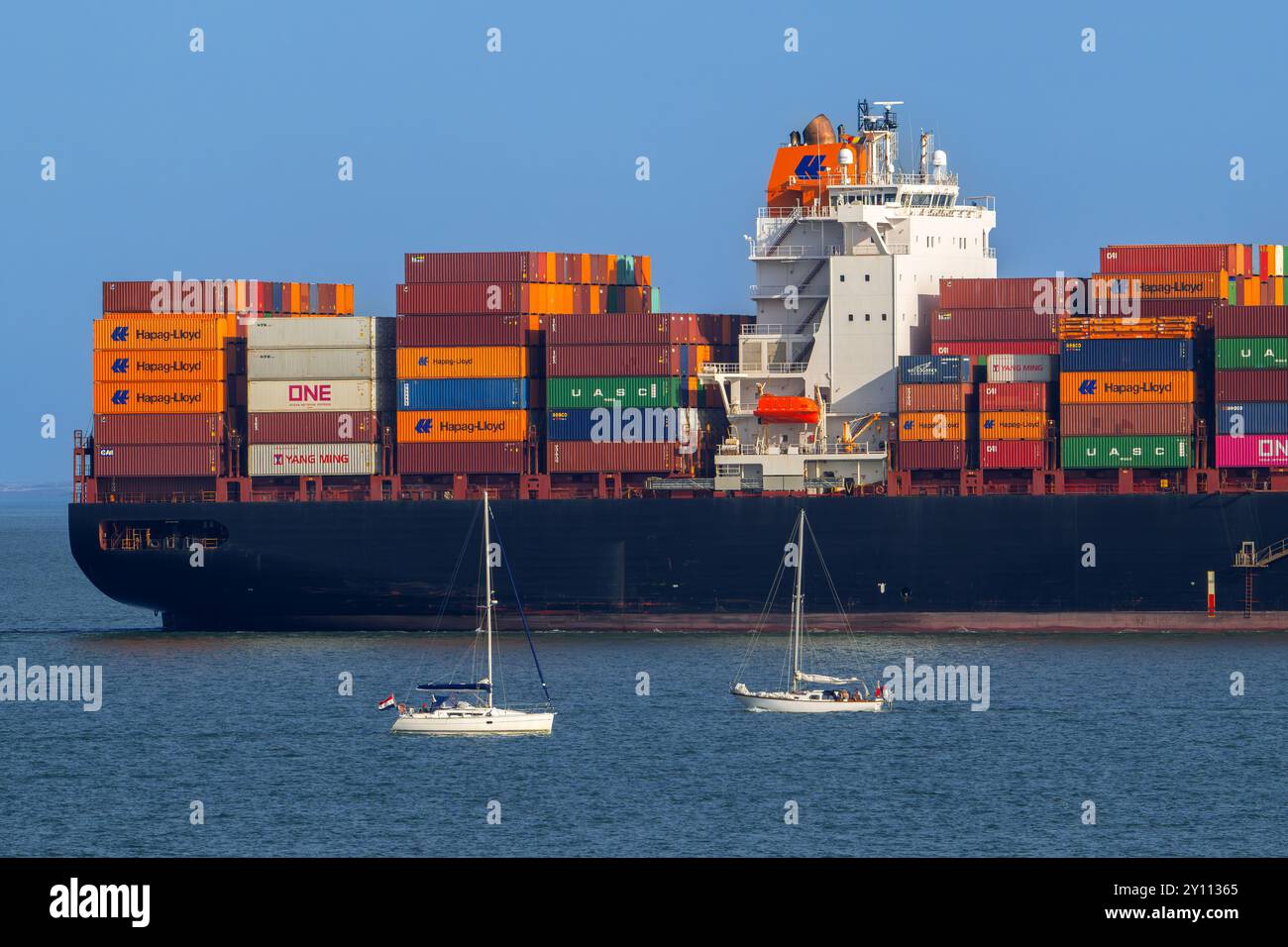 Sailboats sailing past stern of container ship / containership Hudson ...