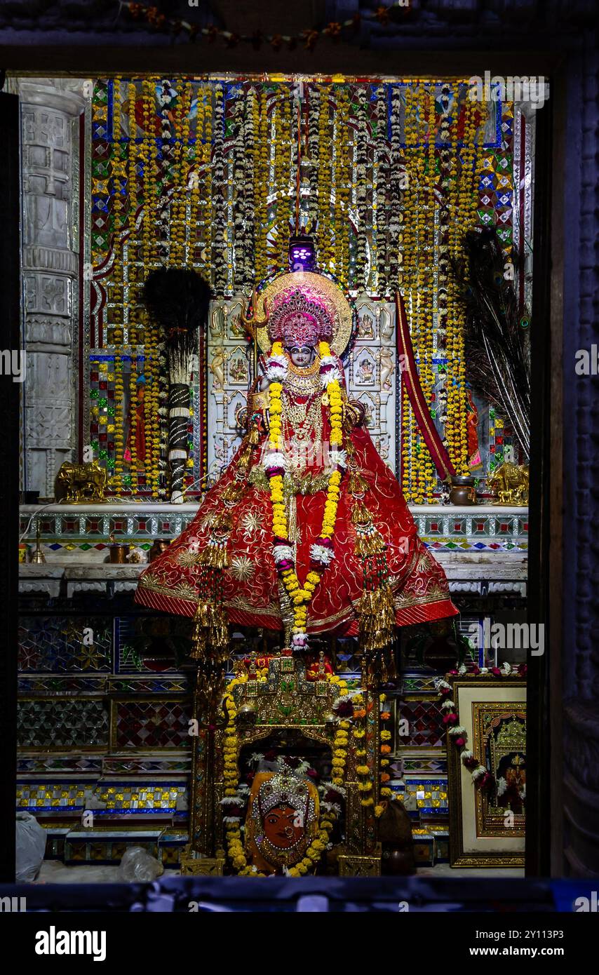 hindu goddess idol decorated with flowers at holy temple at indoor ...