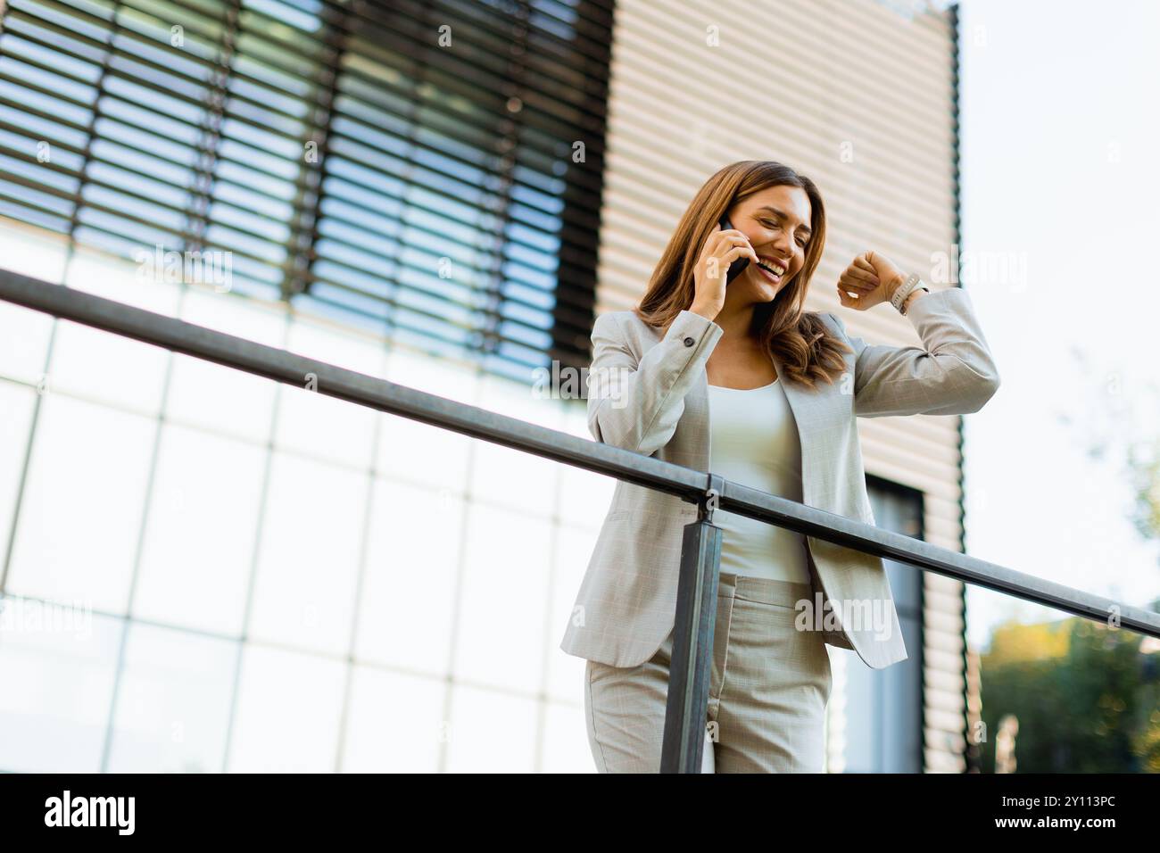 Joyful business woman celebrates a moment outdoors, engaging in a ...