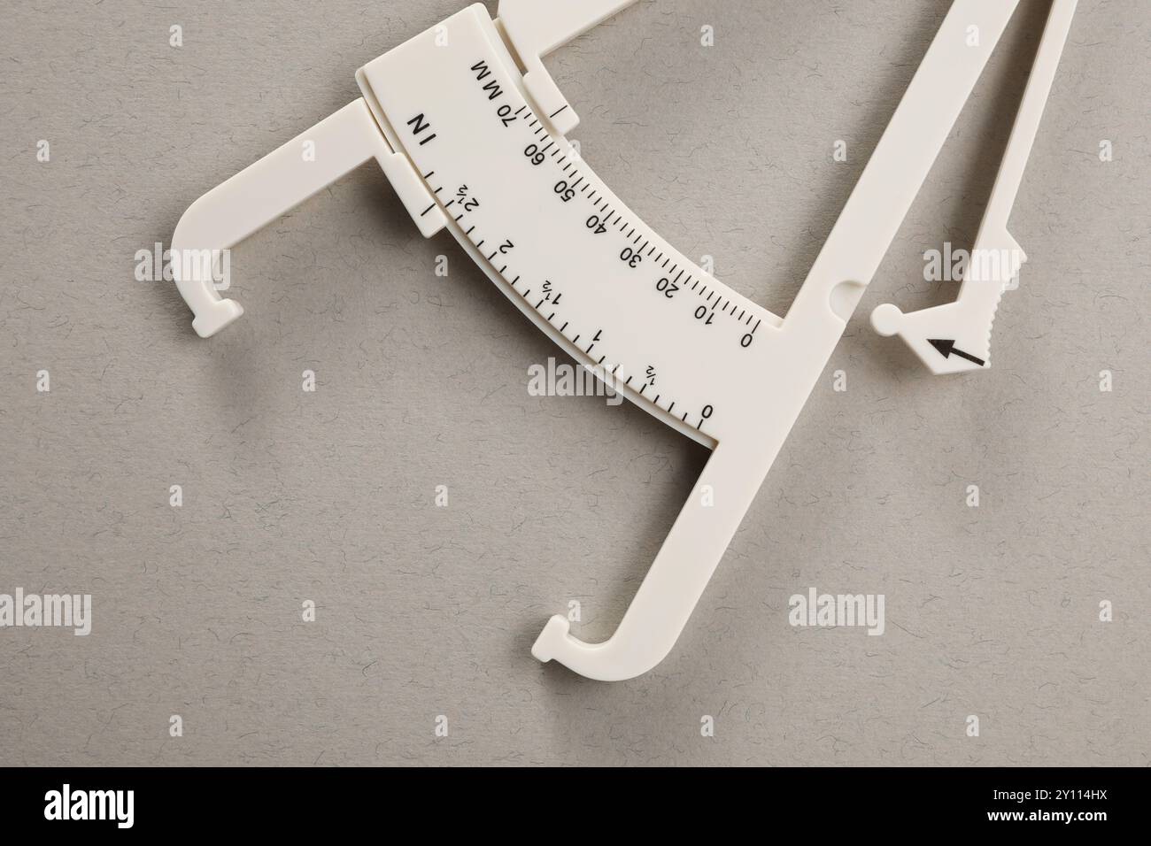 Plastic body fat caliper on grey background, top view Stock Photo - Alamy