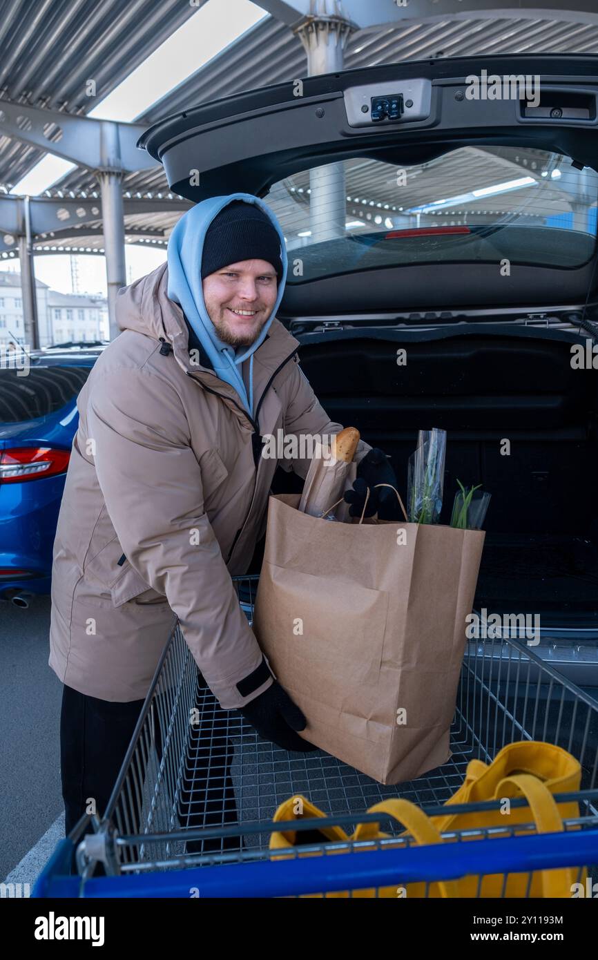 Man Loading Groceries into Car Trunk Stock Photo - Alamy