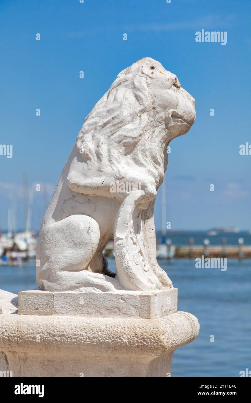 stone statue of the lion of Saint Mark on the balustrade of a bridge ...