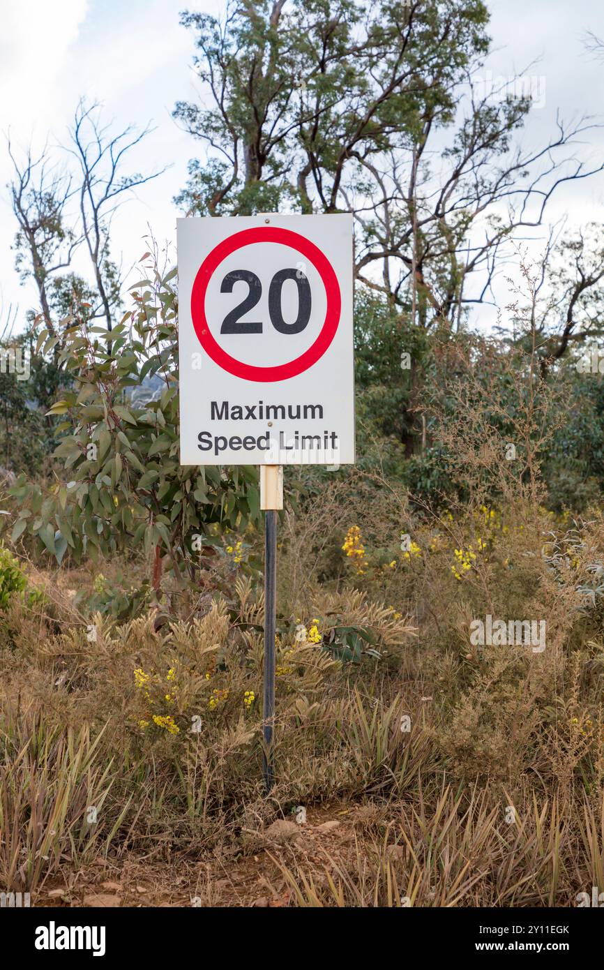 Photograph of a 20 kilometre per hour road sign on a narrow dirt road ...