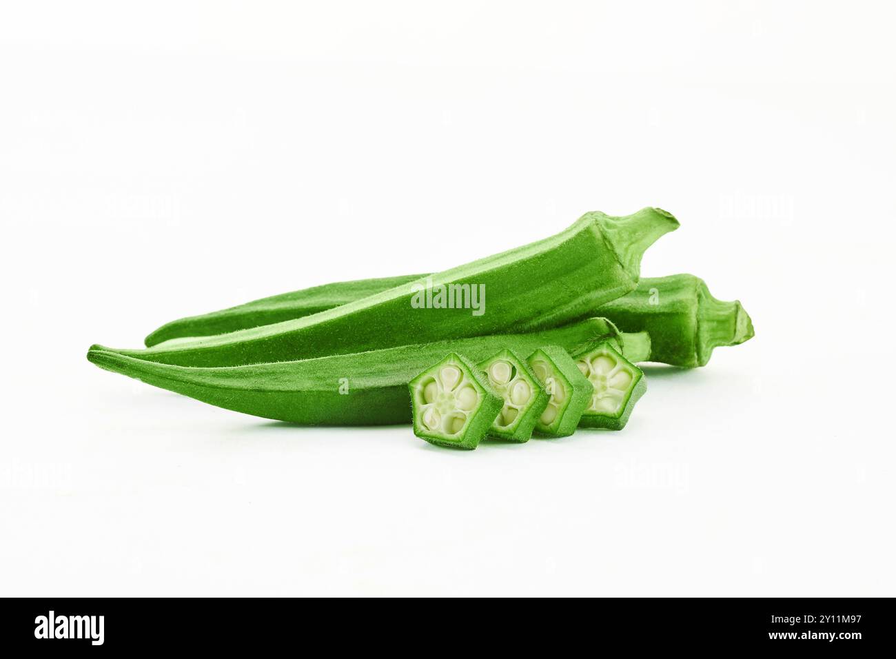 Fresh Okra pods and slices on a white background Stock Photo - Alamy
