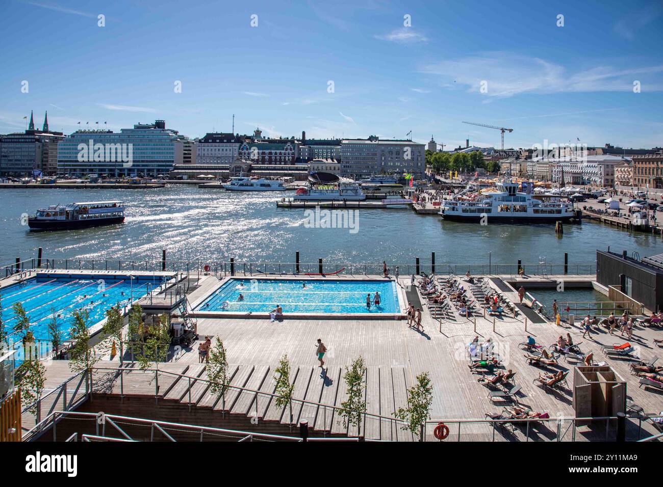 Allas Sea Pool floating deck with swimming pools and sunbather on ...