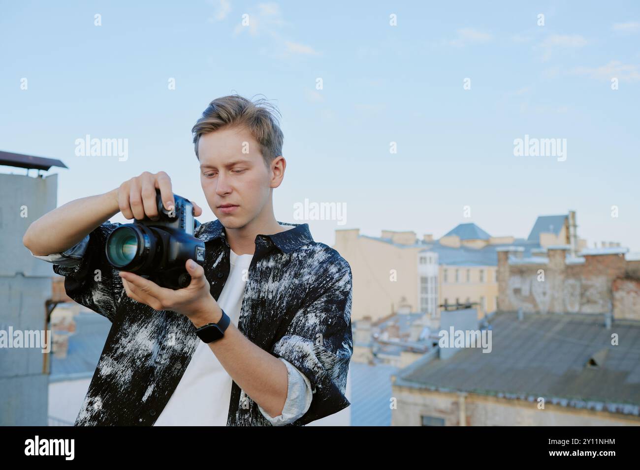 Adjusting Camera Settings on Urban Rooftop Stock Photo - Alamy