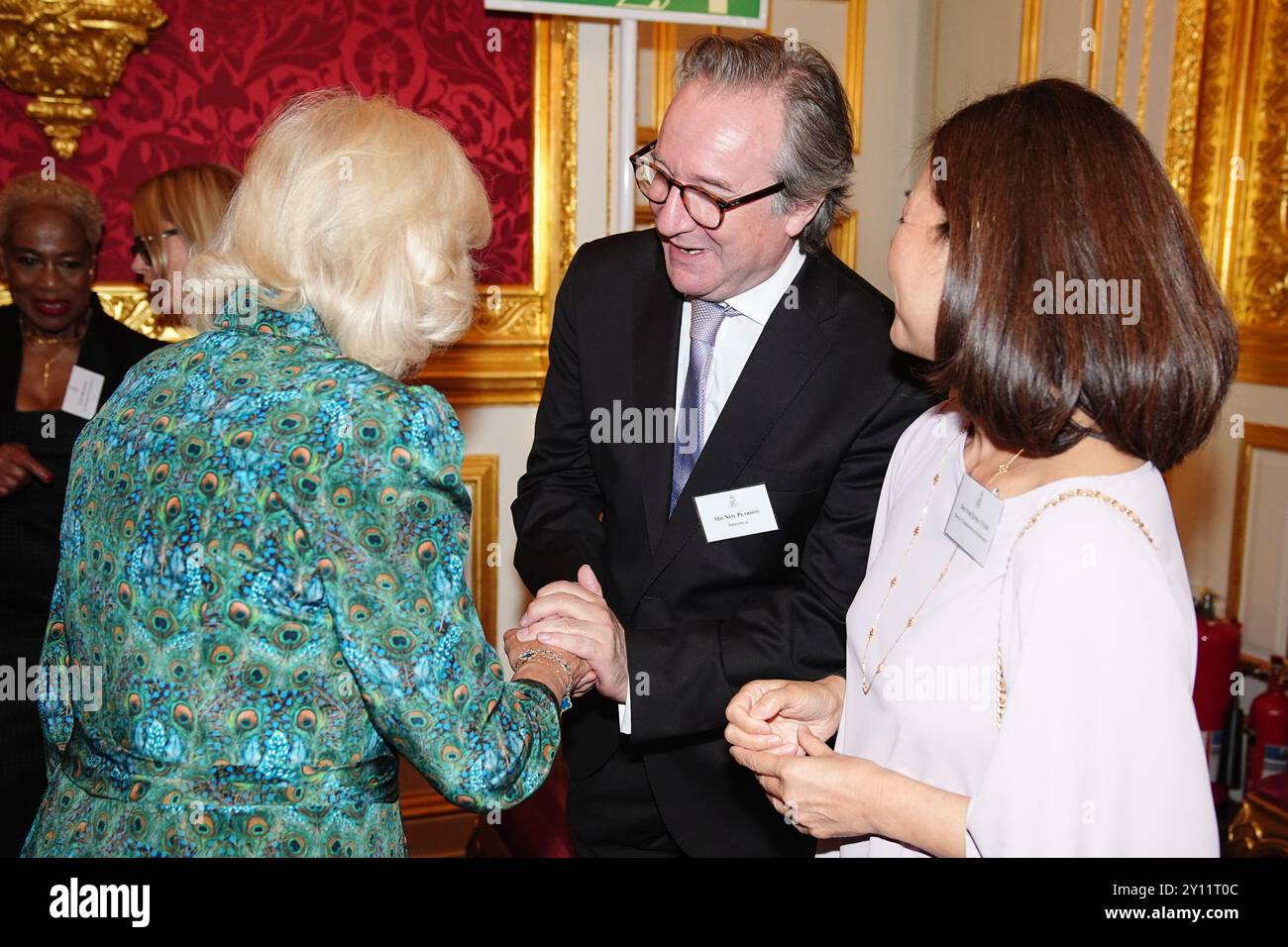 Queen Camilla, Patron of Book Aid International, greets Neil Pearson ...