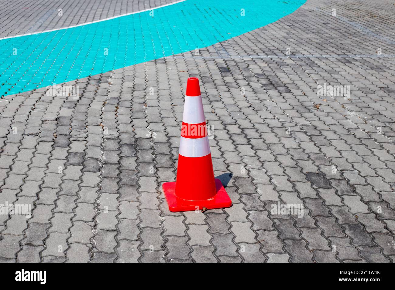 Traffic cone on paving stones. Traffic restriction Stock Photo - Alamy