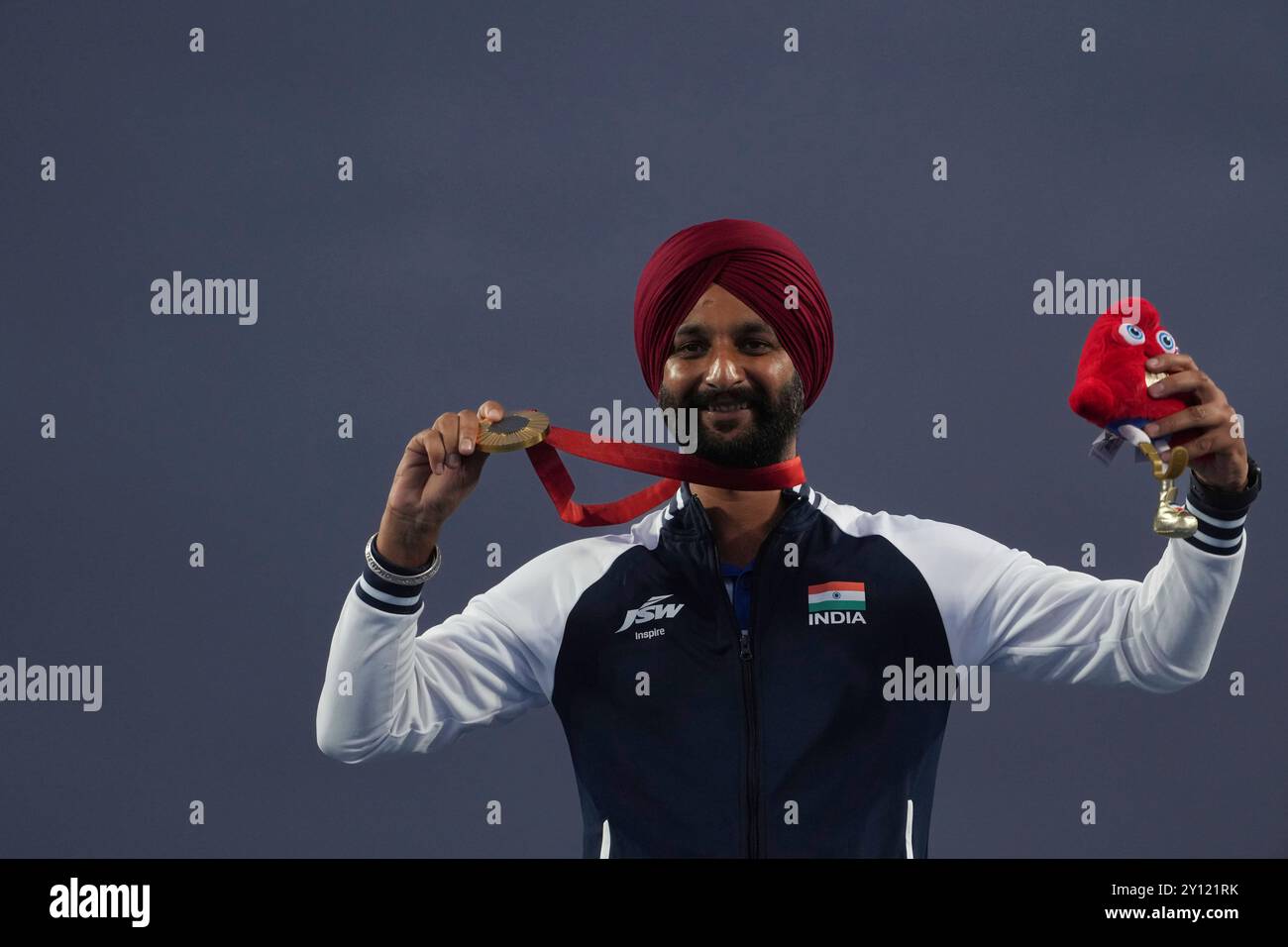 Harvinder Singh of India celebrates on the podium after winning the ...