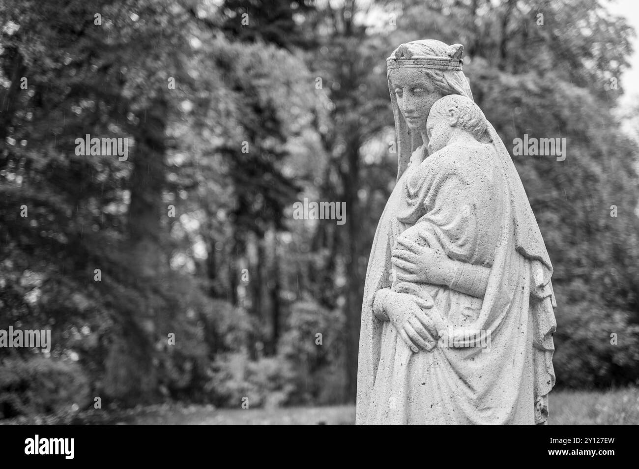 A statue of the Virgin Mary with the Infant Jesus in the park of the ...