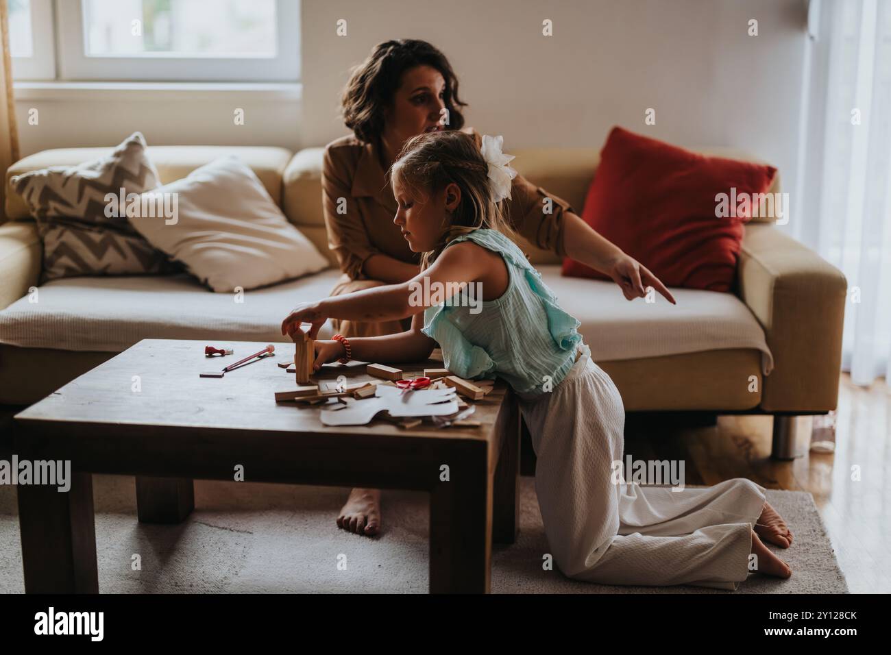 Mother and daughter engaging in creative activities at home Stock Photo ...