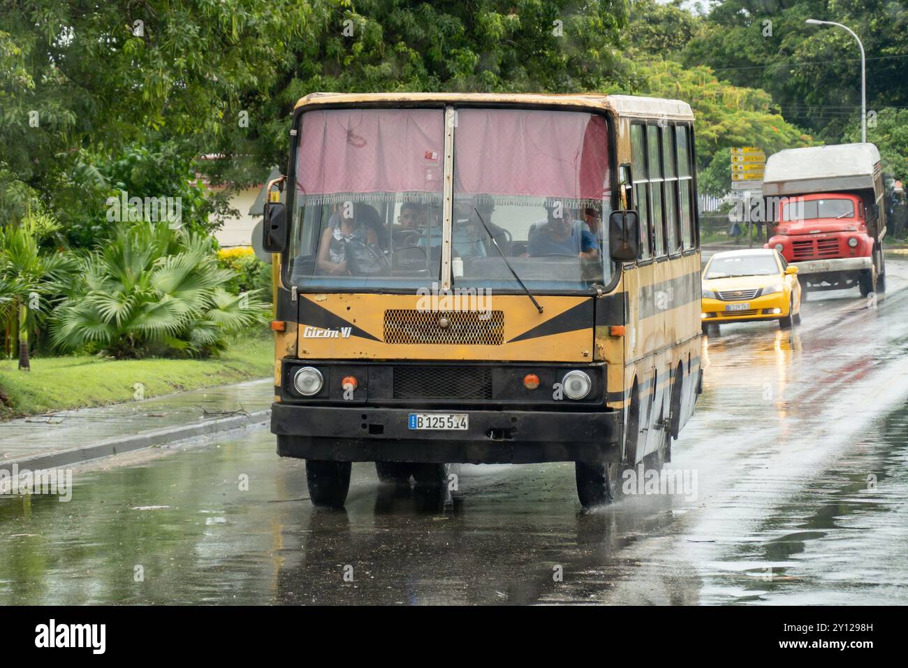CUBA - AUGUST 29, 2023: Old yellow Giron VI Ikarus bus on wet Cuban ...