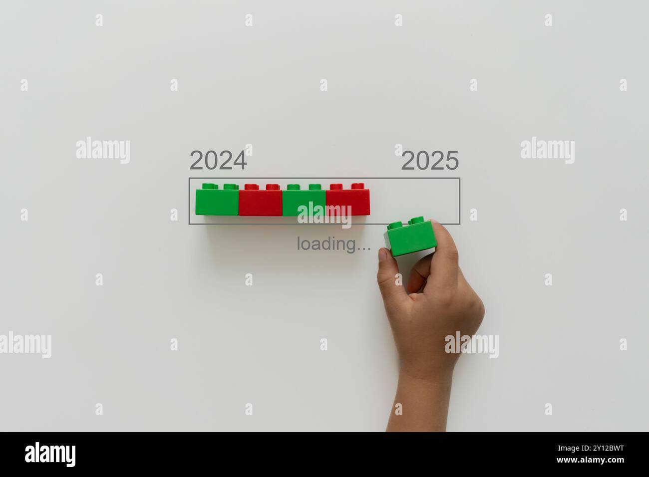 Loading new year 2024 to 2025 with child hand putting plastic block in ...
