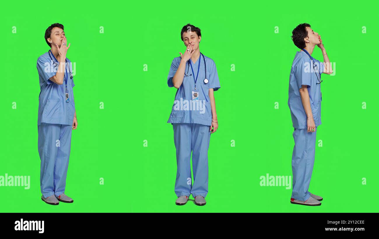 Flirty cute nurse blowing air kisses against greenscreen backdrop ...