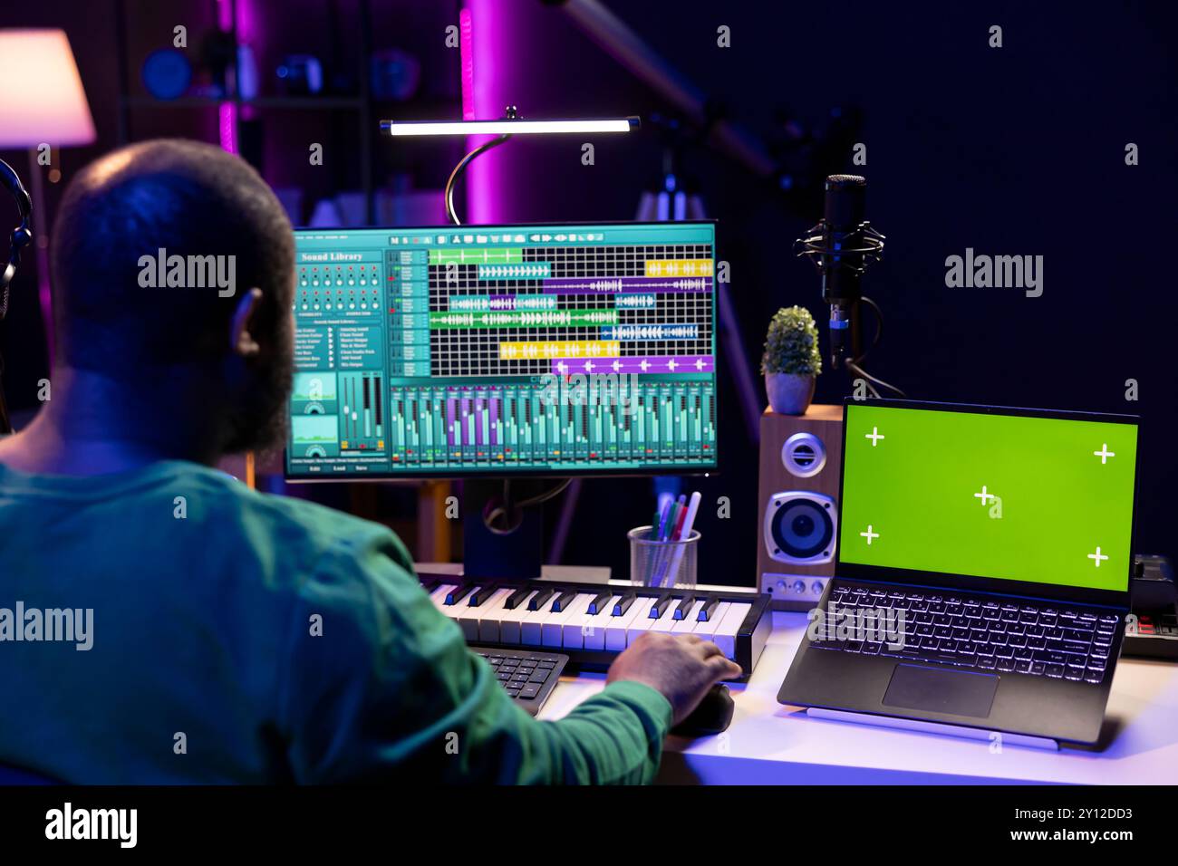 Music producer mixing and mastering songs on digital post production pc ...