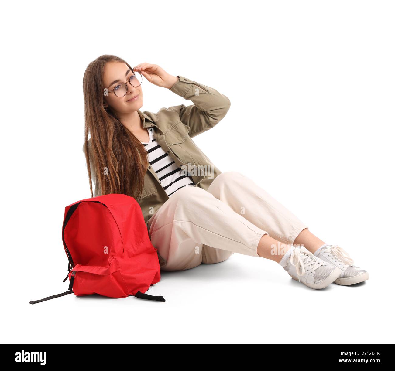 Female student with backpack sitting on white background Stock Photo ...