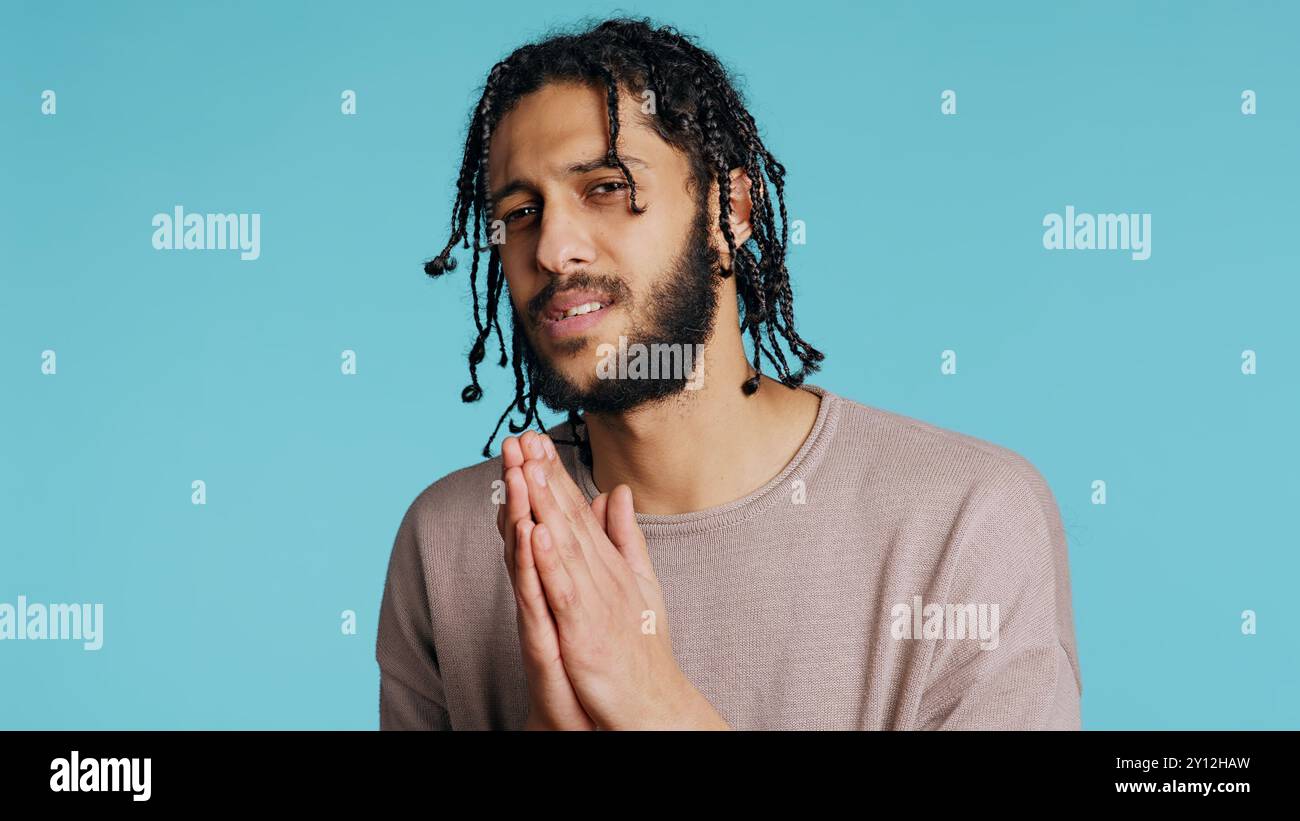 Desperate guy asking for forgiveness, putting hands together in ...