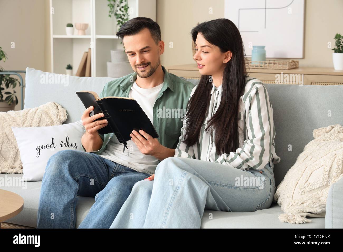 Religious couple reading Holy Bible at home Stock Photo - Alamy