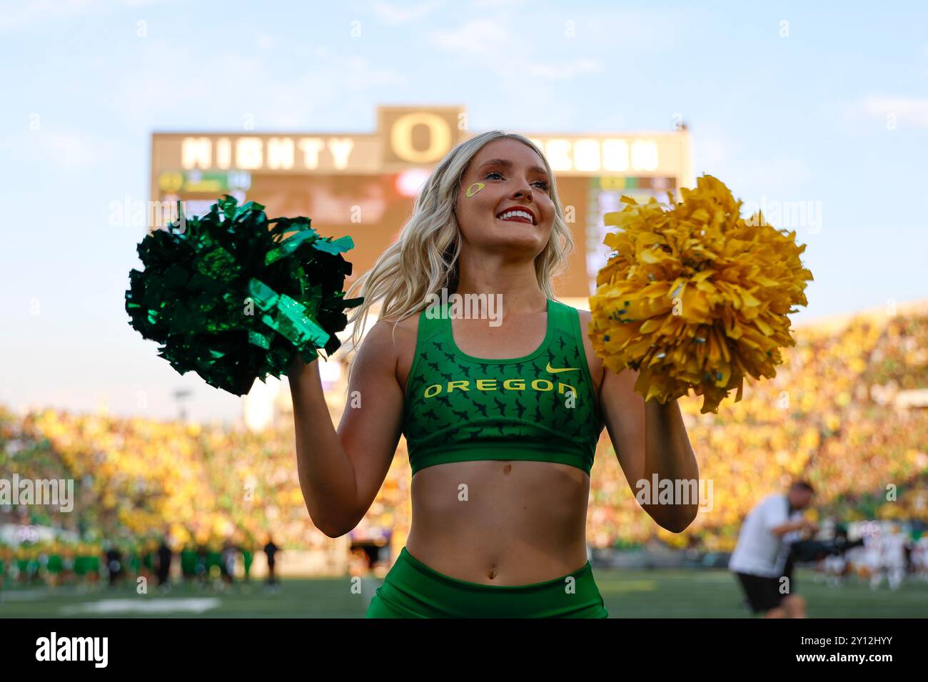 An Oregon Ducks cheerleader entertains the crowd during the first half ...