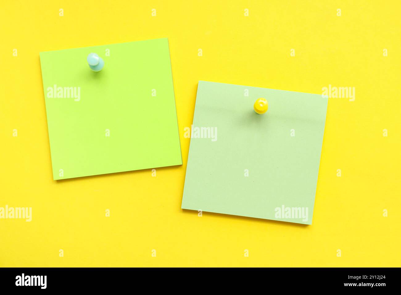 Paper notes pinned on yellow background Stock Photo - Alamy