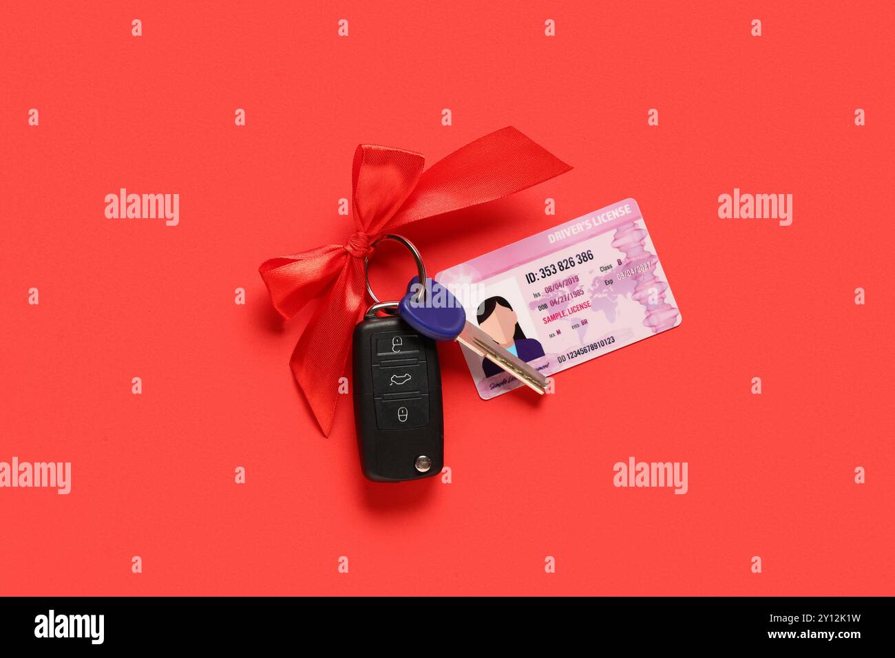 Gift keys of new car with bow and driver license on red background ...