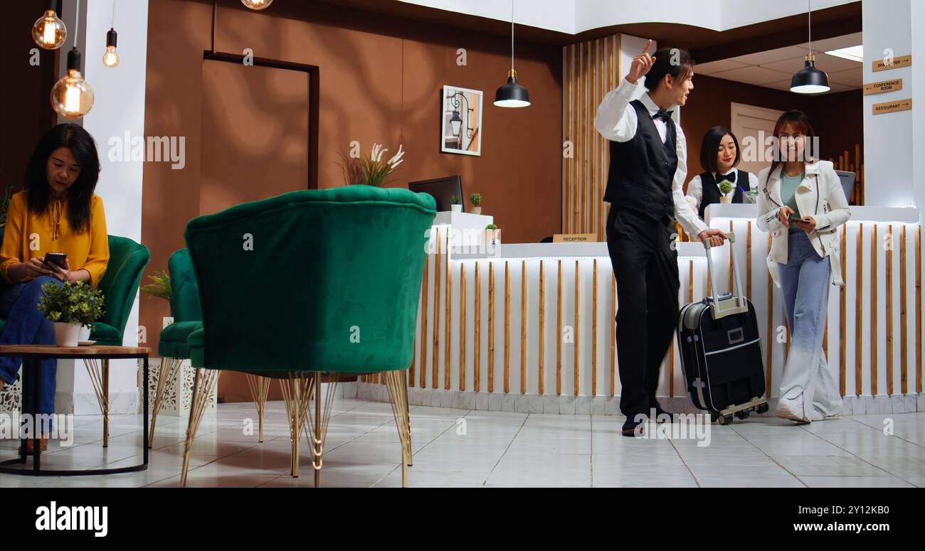 After check in process, receptionist handing over passport and key for ...