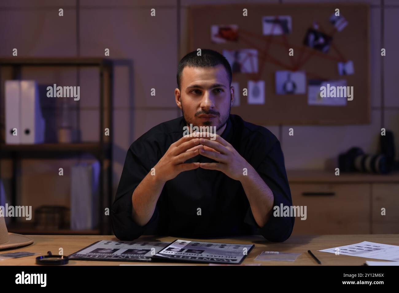 Crime investigator sitting in office hi-res stock photography and ...