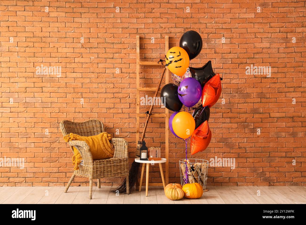 Interior of living room with Halloween balloons, ladder and armchair ...