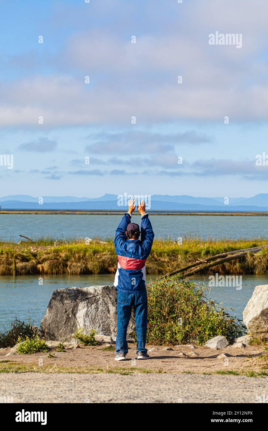 Asian man performing his morning routine at Gary Point Park in ...