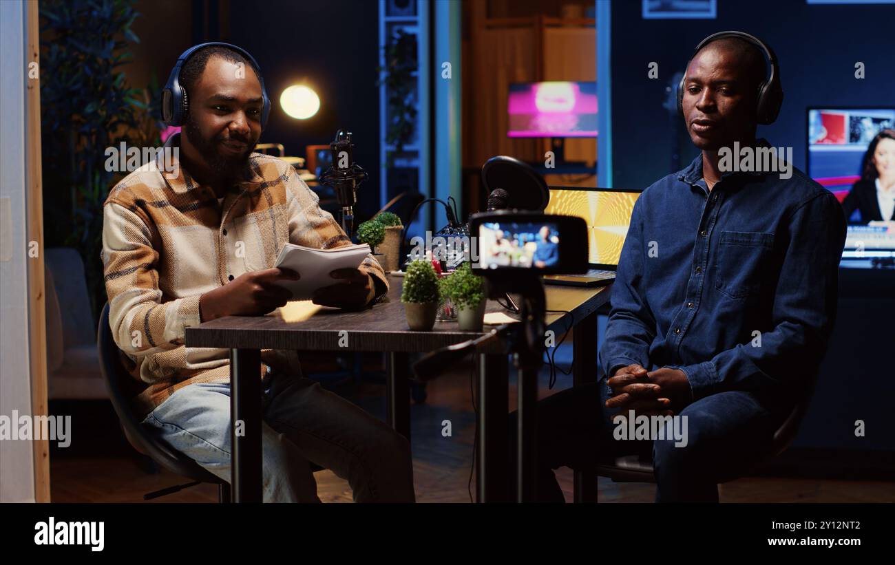 Content creator recording interview with professional camera in studio ...