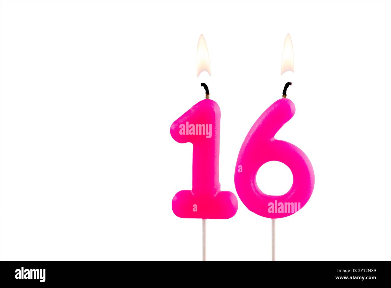 Pink number 16 birthday candle lit on white background Stock Photo - Alamy