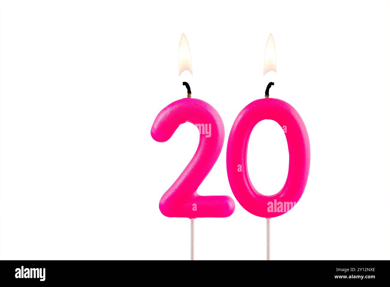 Pink number 20 birthday candle lit on white background Stock Photo - Alamy