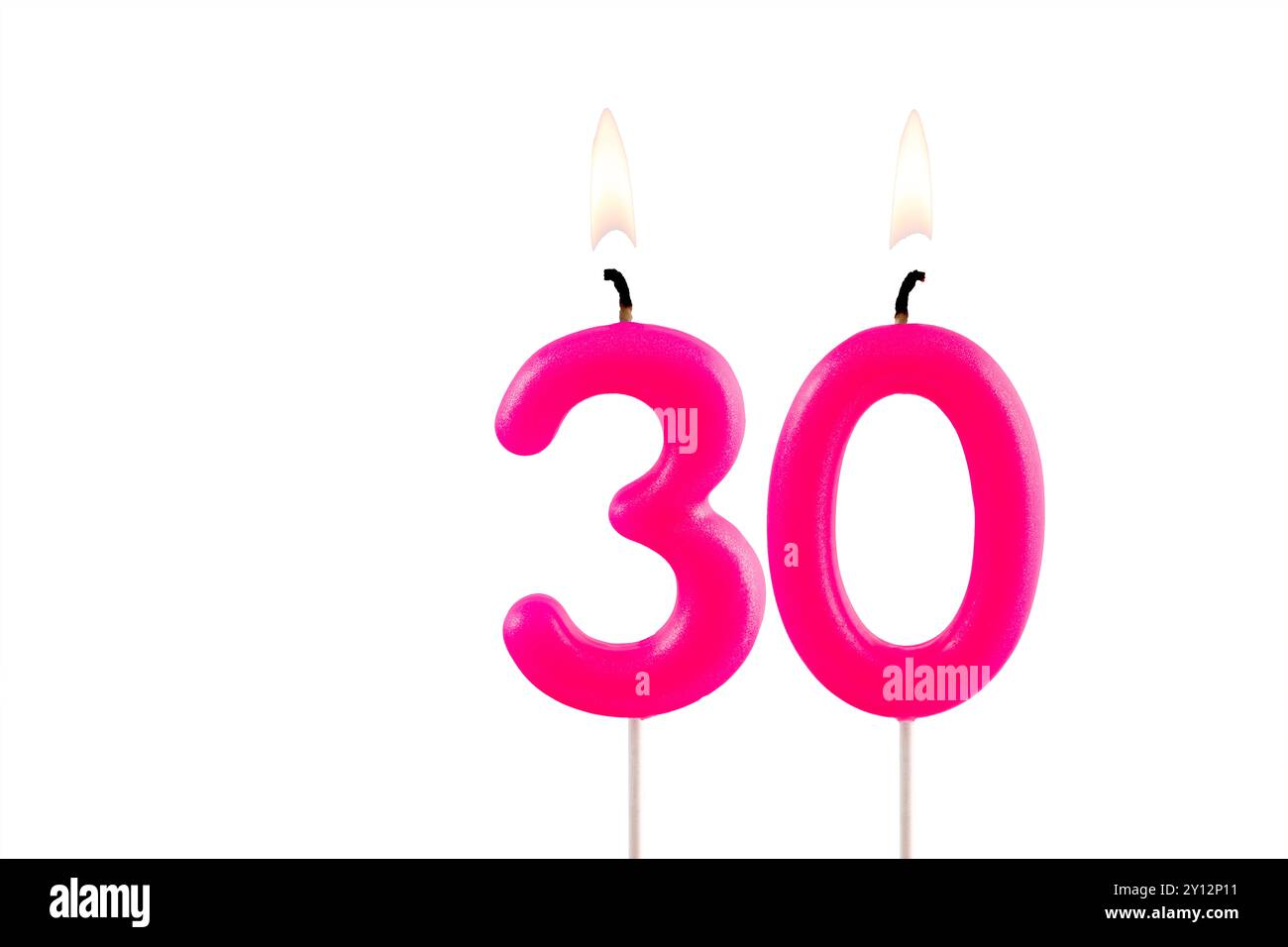 Pink number 30 birthday candle lit on white background Stock Photo - Alamy