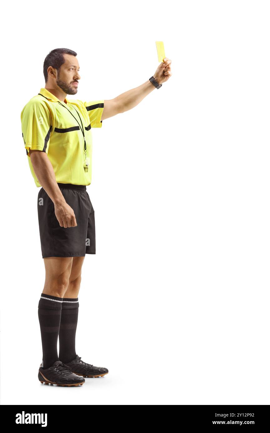 Full length shot of a football referee holding a yellow card isolated ...