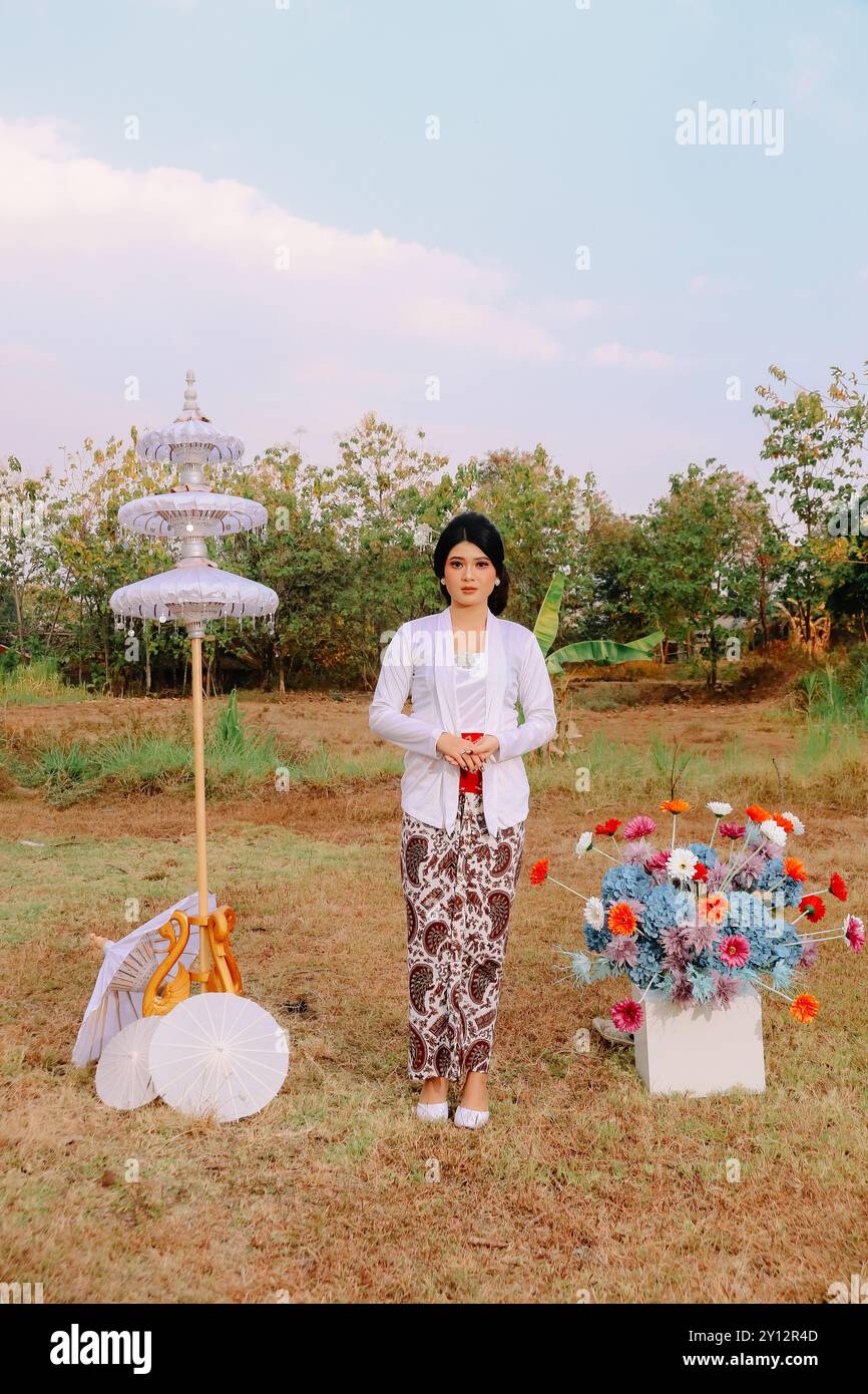 Full body charm of young Asian woman standing among decorations wearing ...