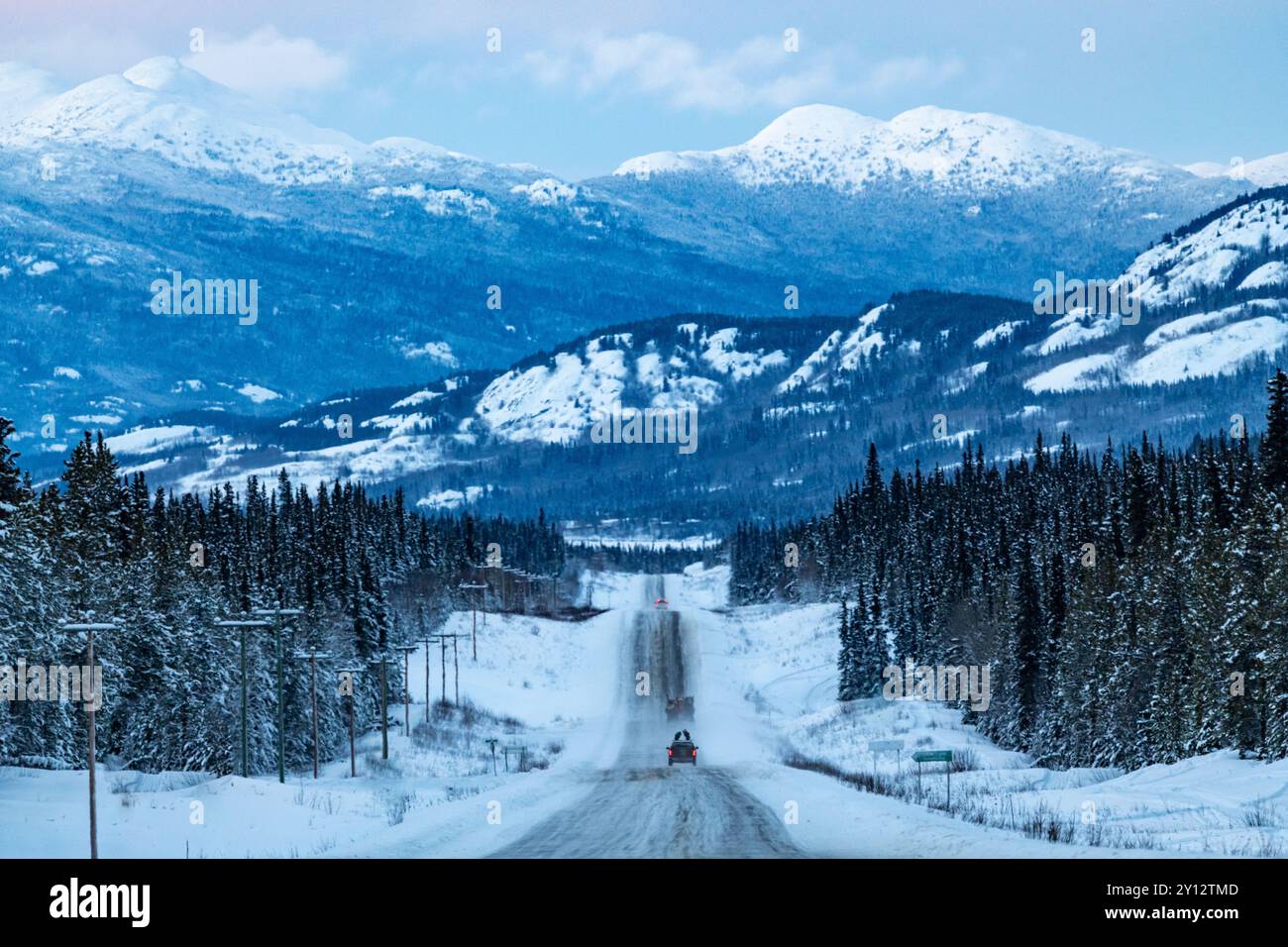 Wilderness road, highway in northern Canada with mountains towering ...