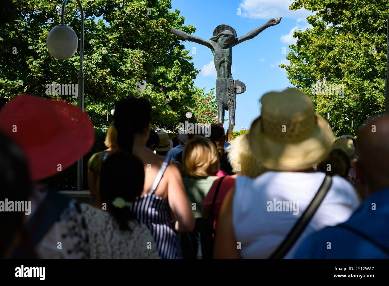 People venerating the statue of the Risen Christ in Medjugorje. The ...