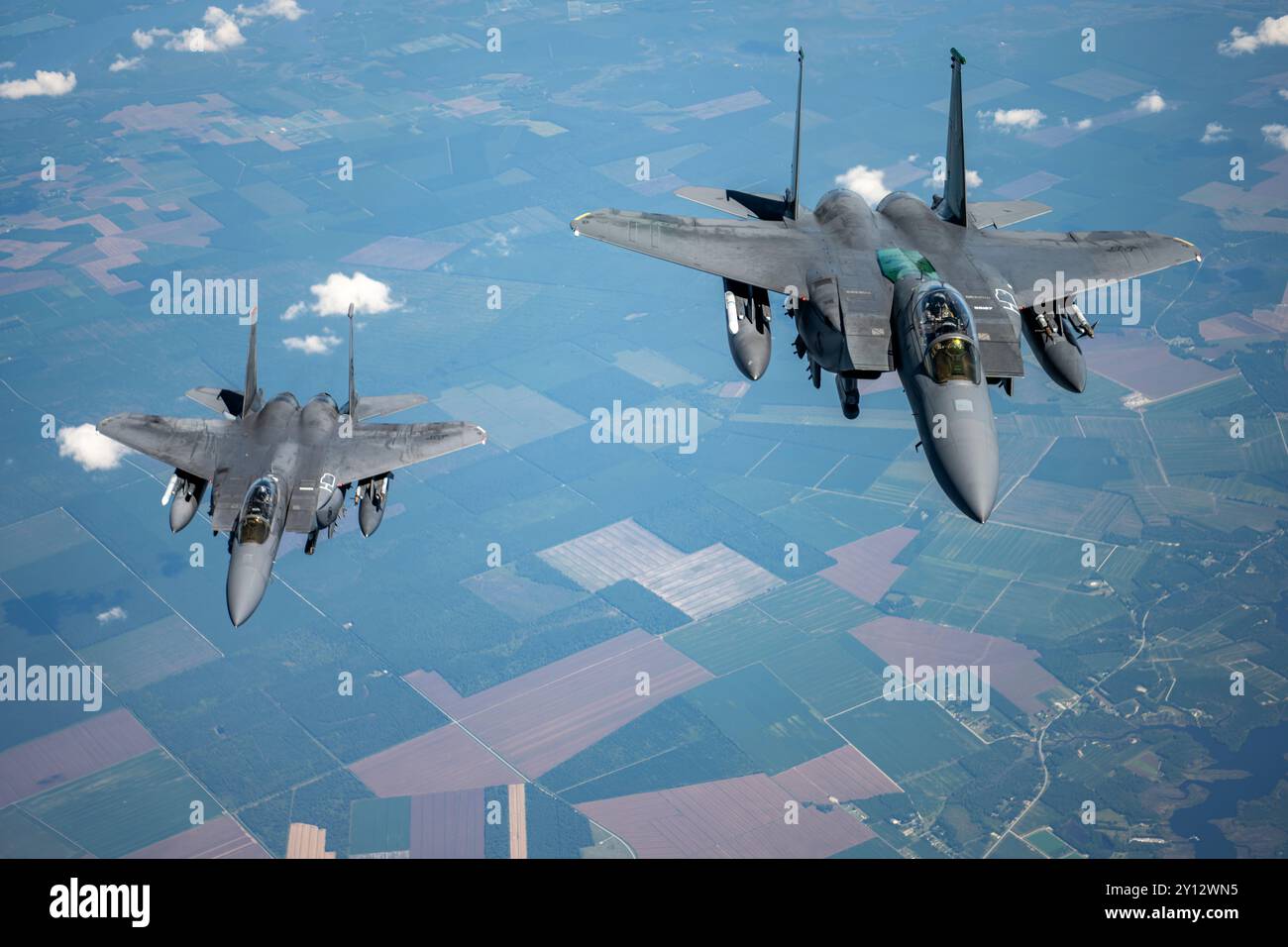 Two F-15 Strike Eagles, assigned to the 4th Fighter Wing, fly in ...