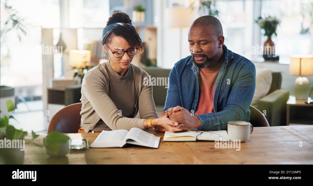 Couple, holding hands and praying with bible for religion or spiritual ...