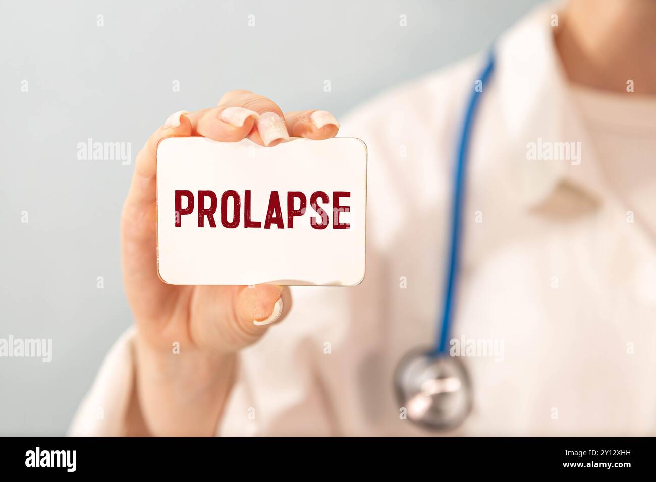 Pills, ampoules and a white card with the text PROLAPSE on a light blue ...