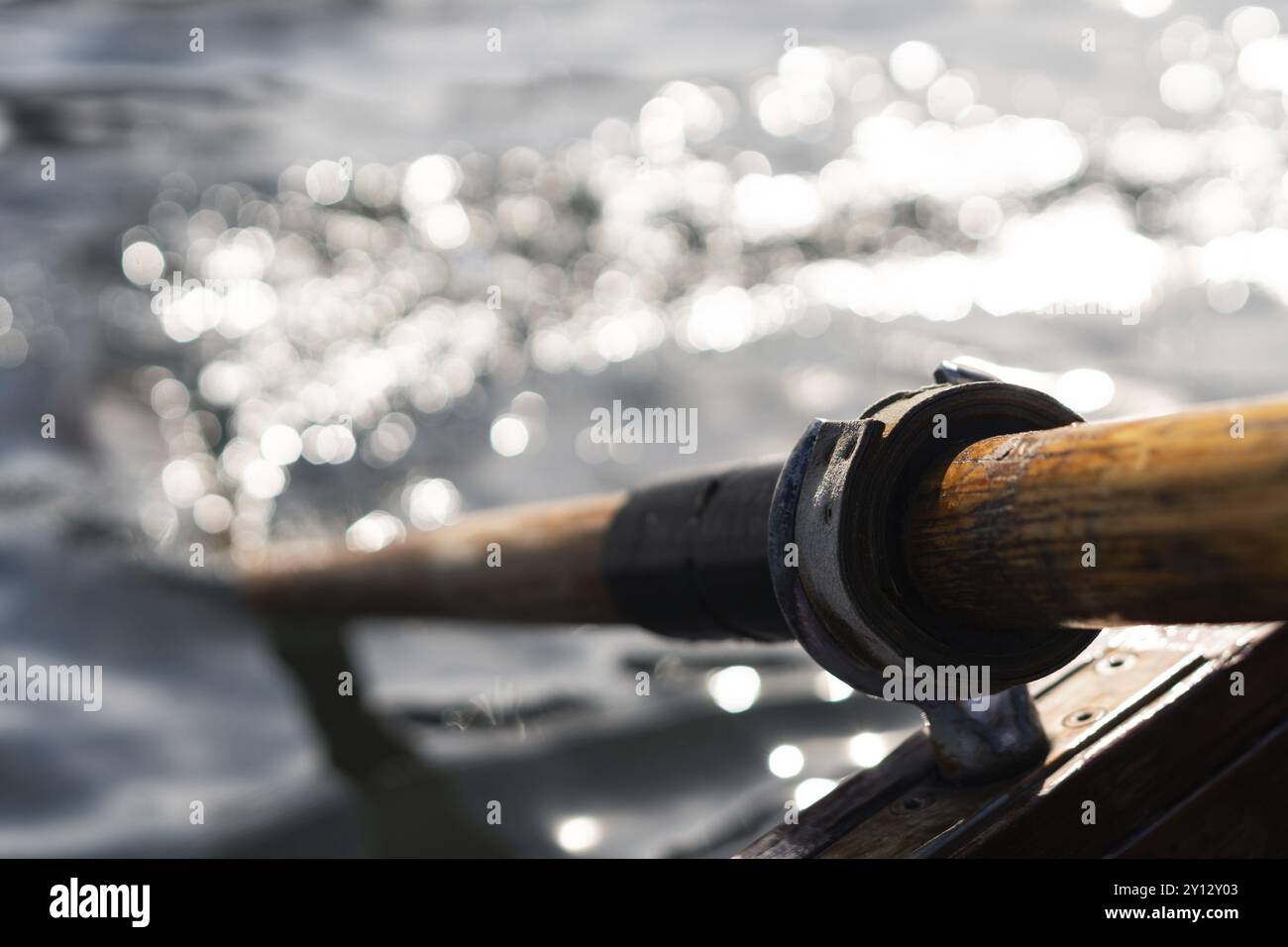 Closeup photo of wooden paddle used for rowing in the water, lake Bled ...