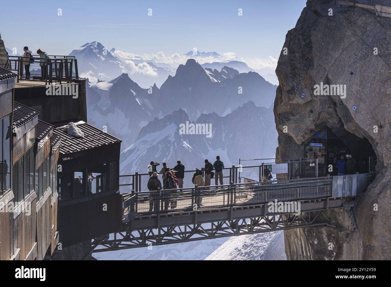 Tourists on viewing platform in front of mountains, mountain station ...