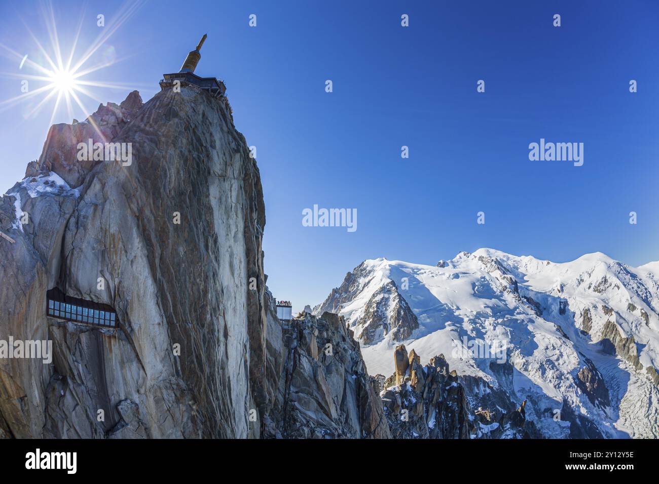Mountain station and mountain peak with glacier in sunlight, backlight ...